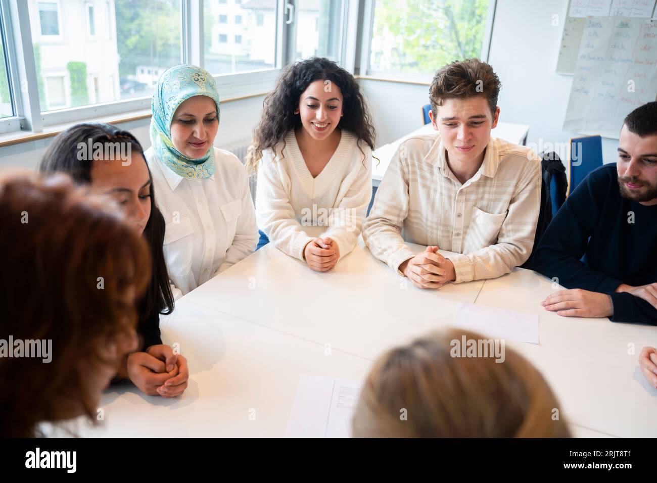 Multicultural people sitting around table hi-res stock photography and ...