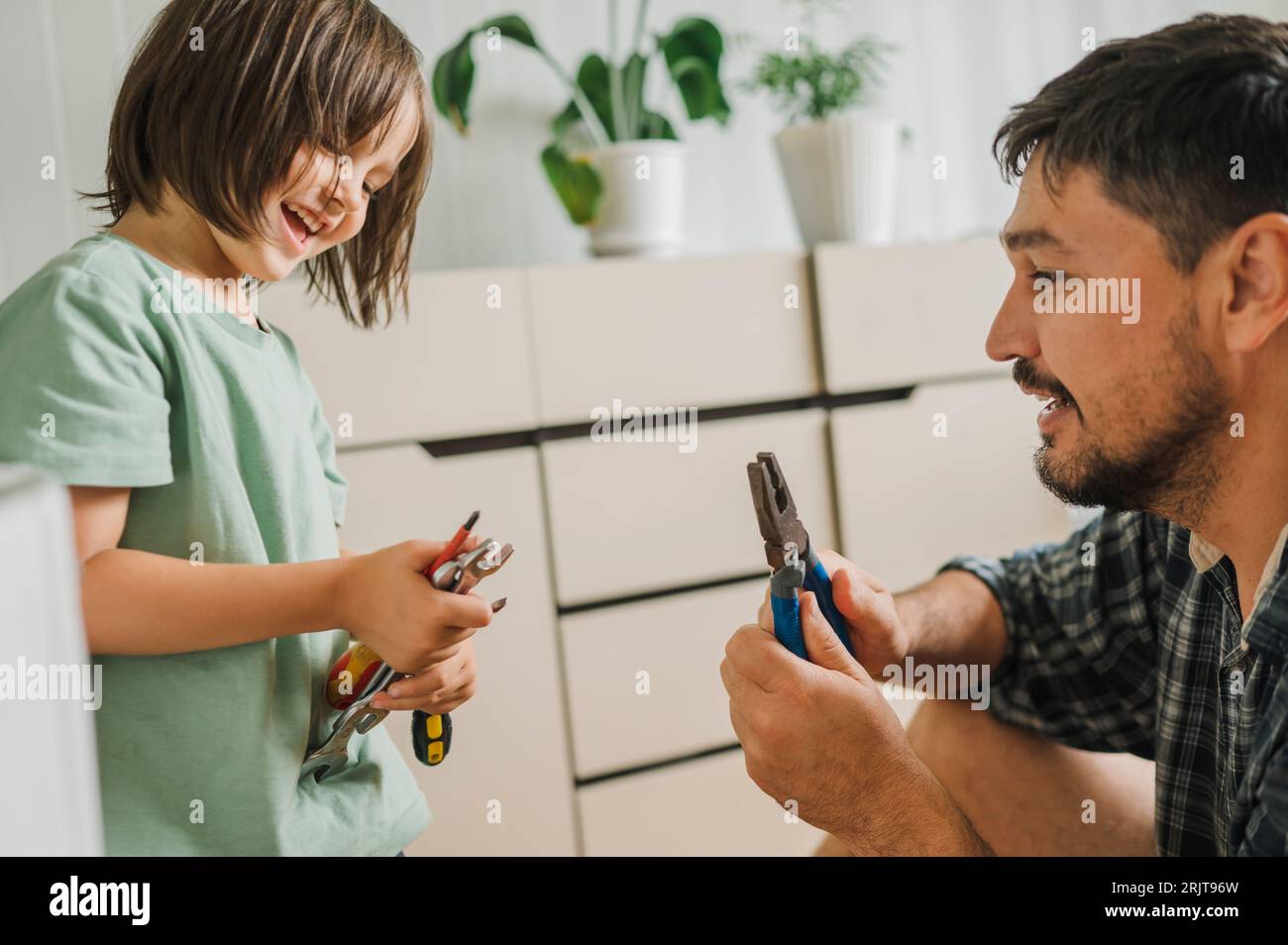 Two men holding tools hi-res stock photography and images - Alamy
