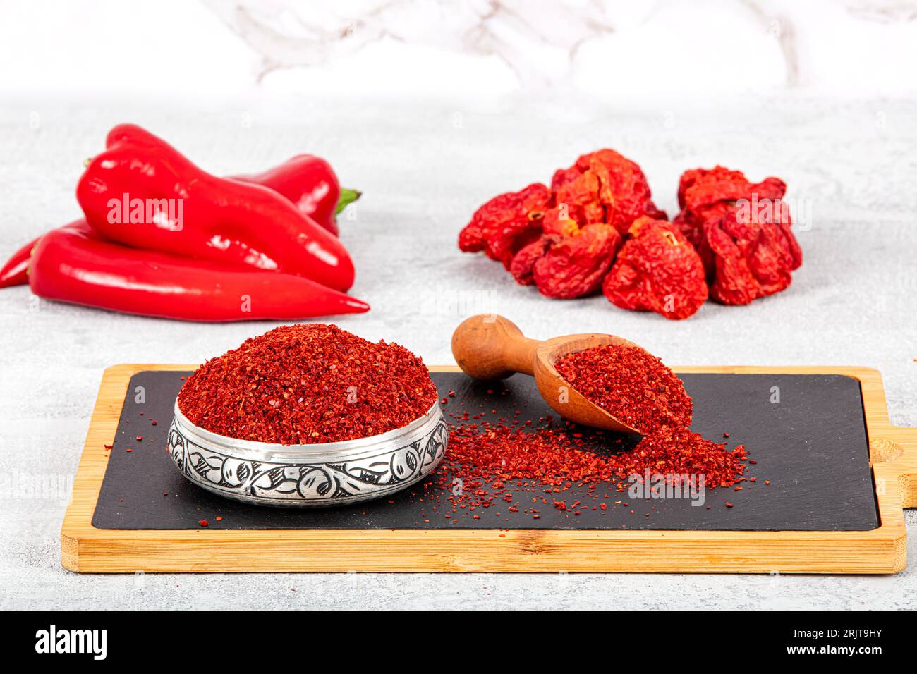 Sweet pepper drying. Ground of red pepper in wooden bowl with raw ...