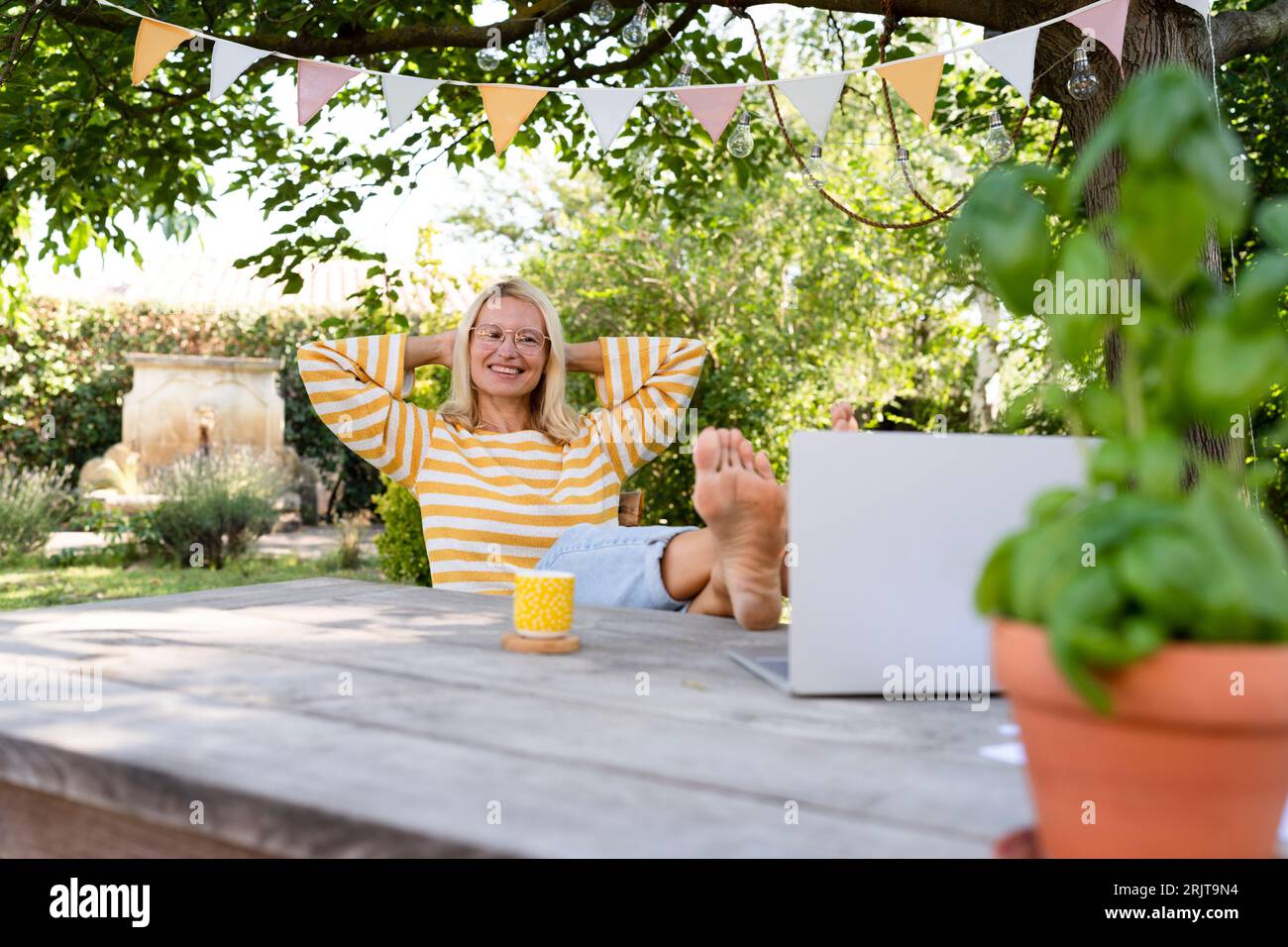 Woman sitting table feet up hi-res stock photography and images - Alamy