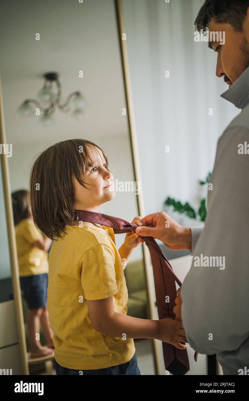 Father helping son adjust hi-res stock photography and images - Alamy
