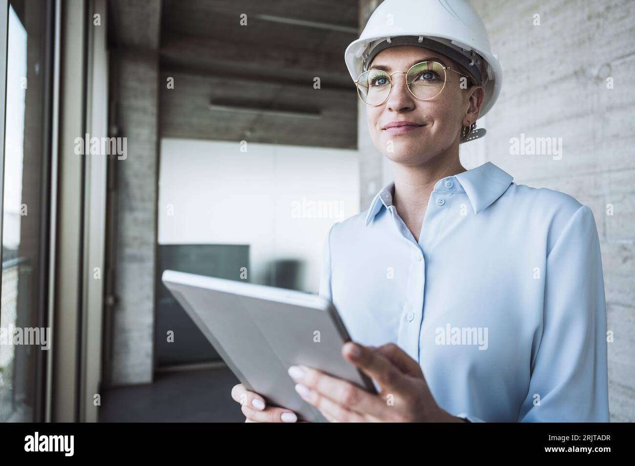 Smiling female engineer wearing helmet hi-res stock photography and ...
