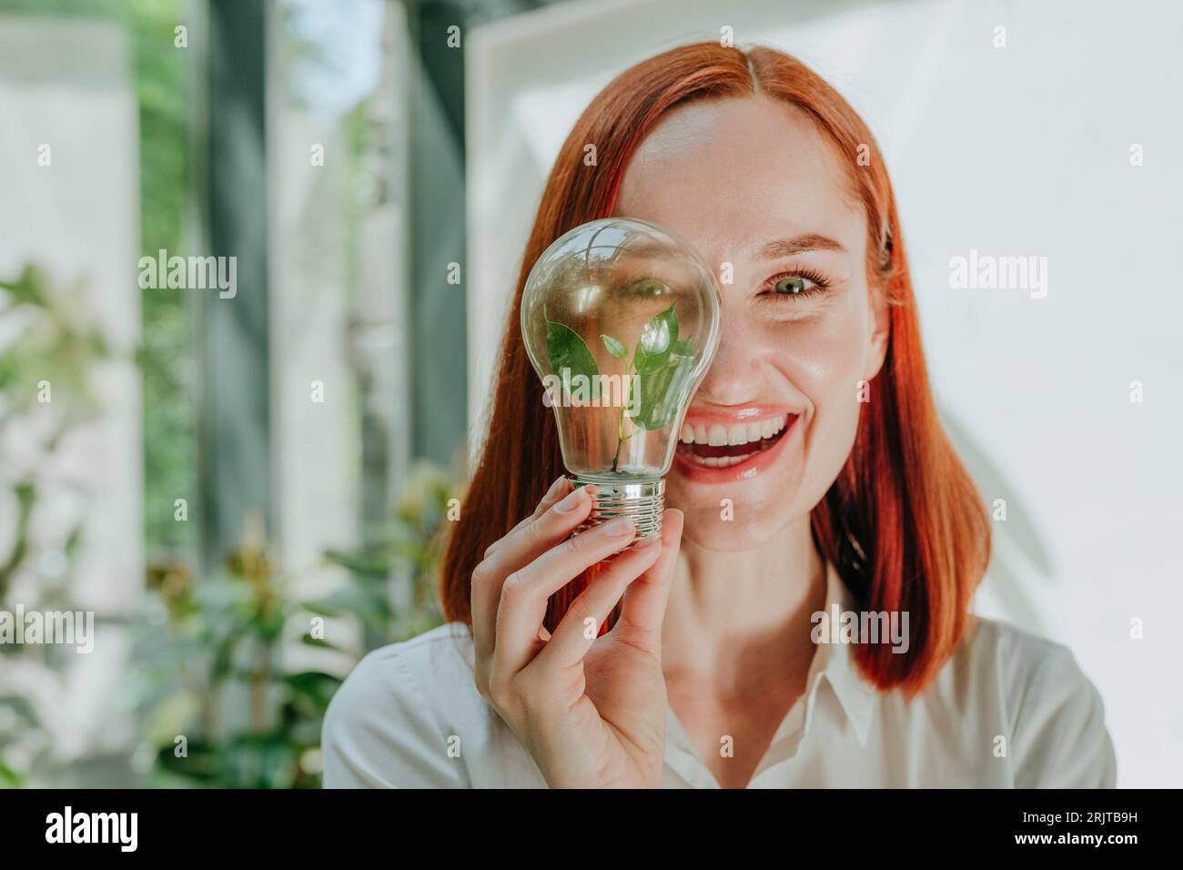 Businesswoman looking through leaf hi-res stock photography and images ...