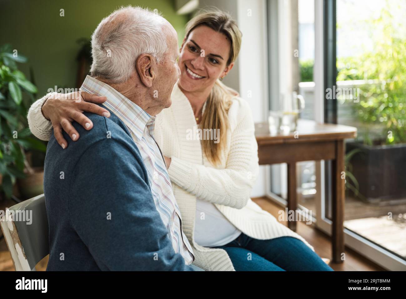 Happy woman caring and supporting father at home Stock Photo - Alamy