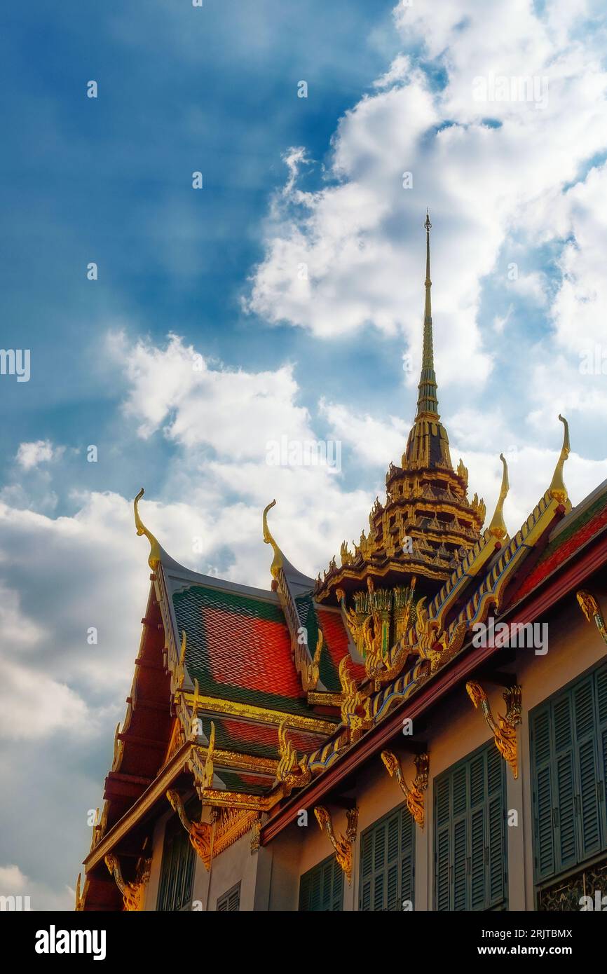 Against a backdrop of clear blue sky, an exquisite Thai temple with a ...