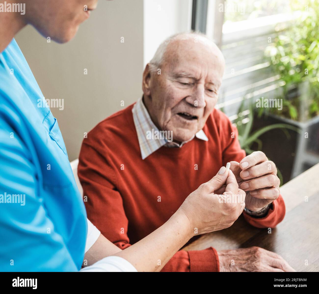 Nurse giving senior man hi-res stock photography and images - Alamy