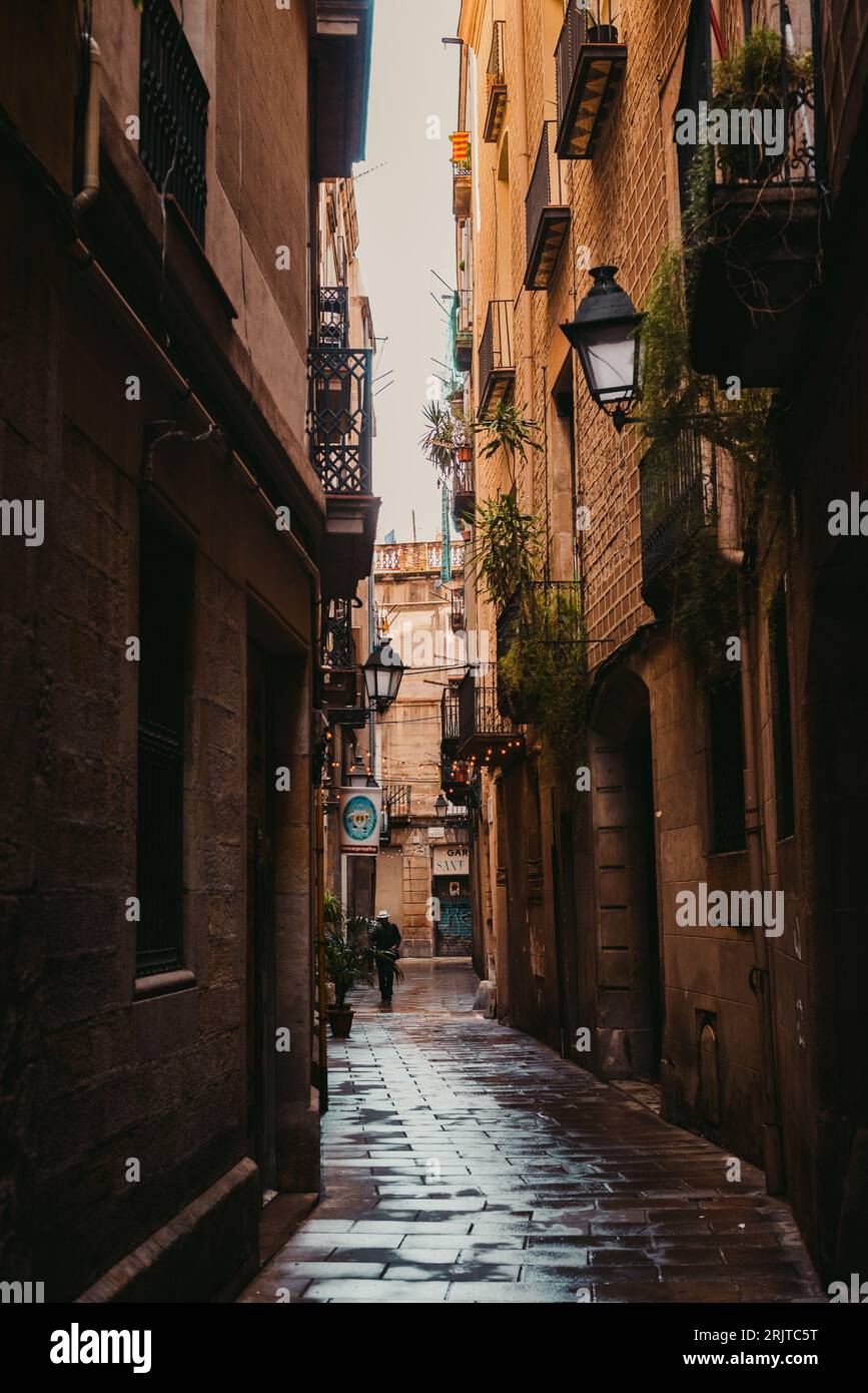 Two people walking down a picturesque cobblestone street illuminated by ...