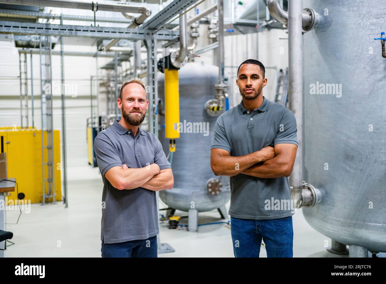 Confident male employees standing hi-res stock photography and images ...