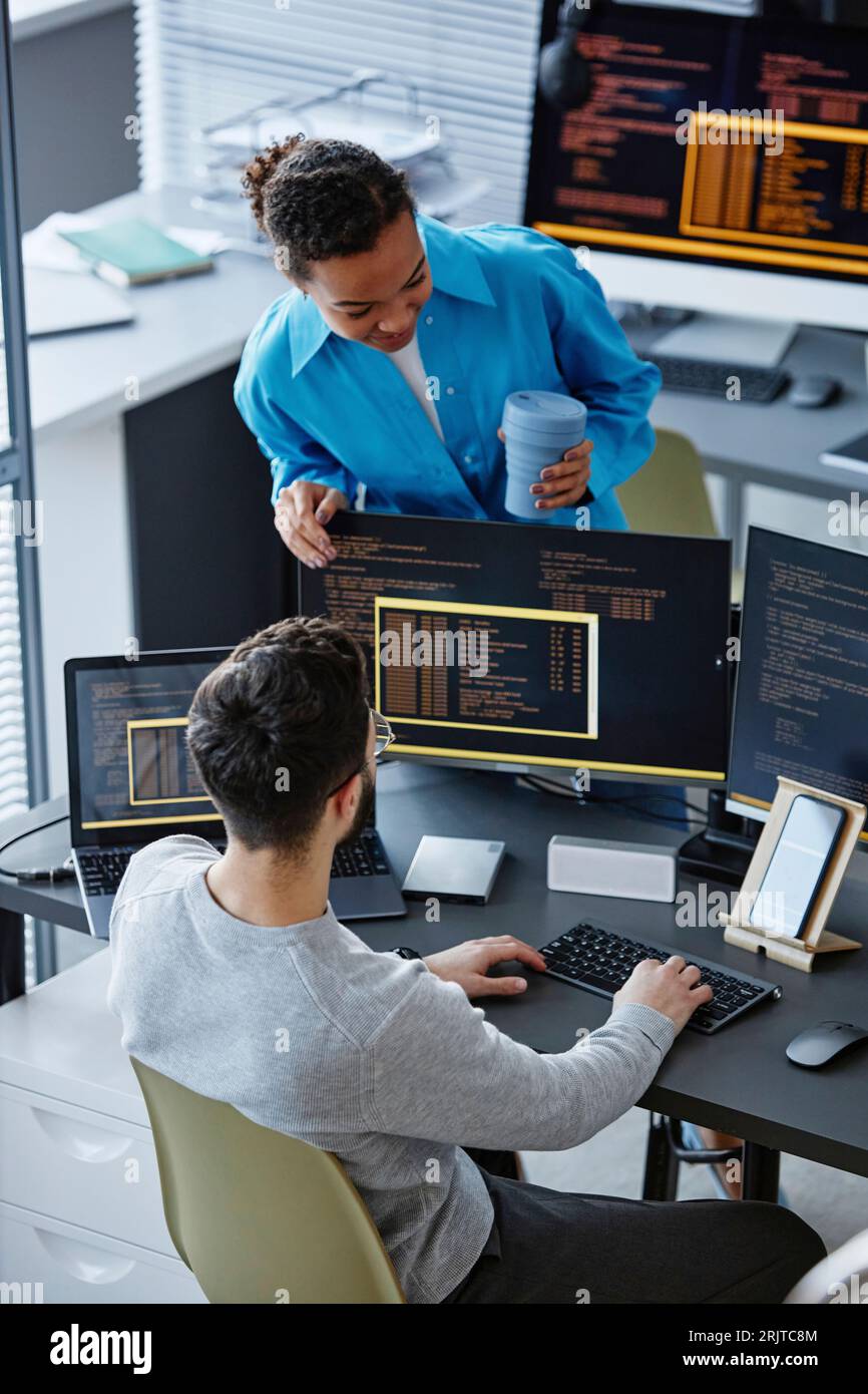 Male programmer discussing colleagues hi-res stock photography and ...