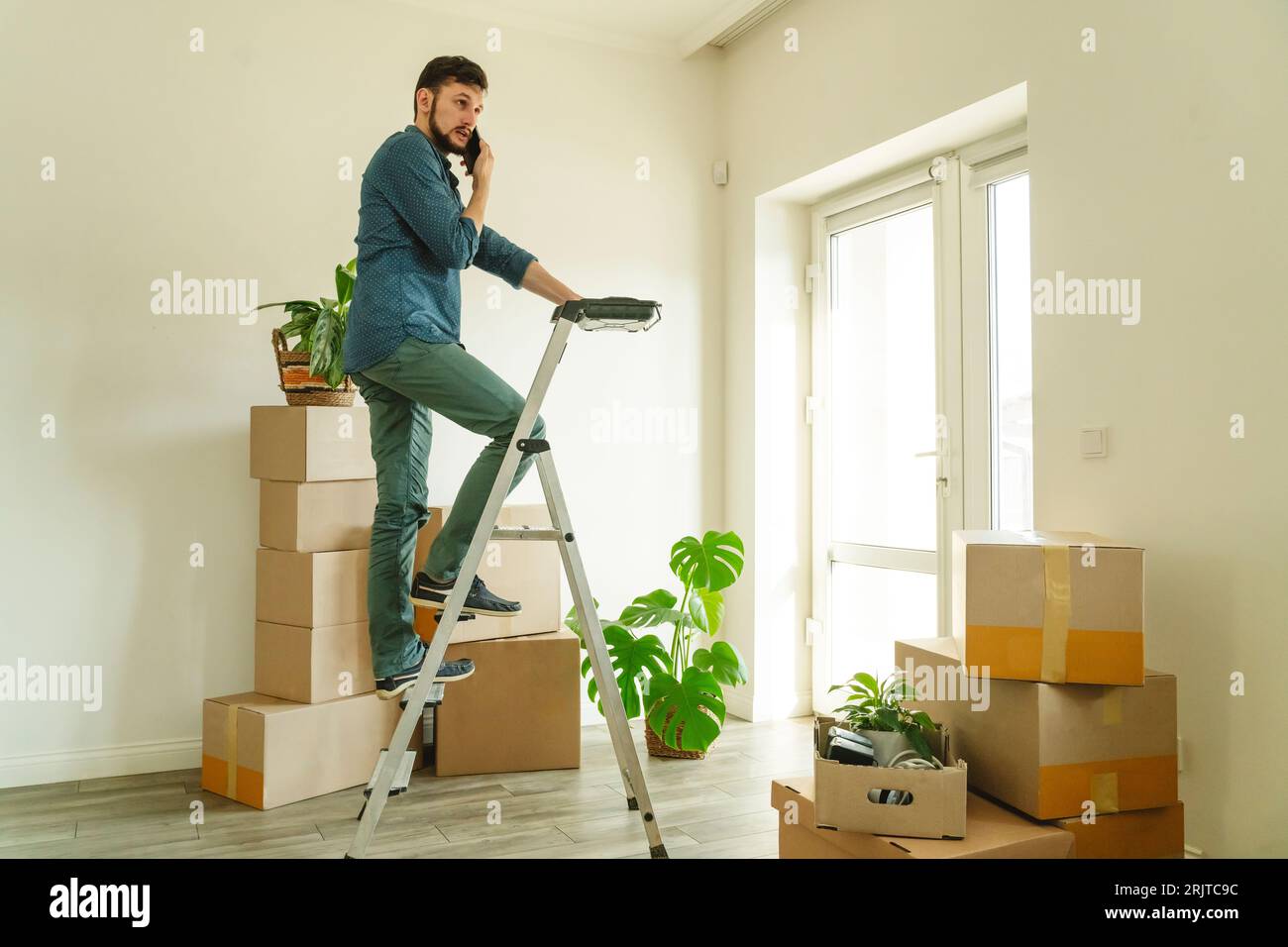 Man climbing window hi-res stock photography and images - Alamy
