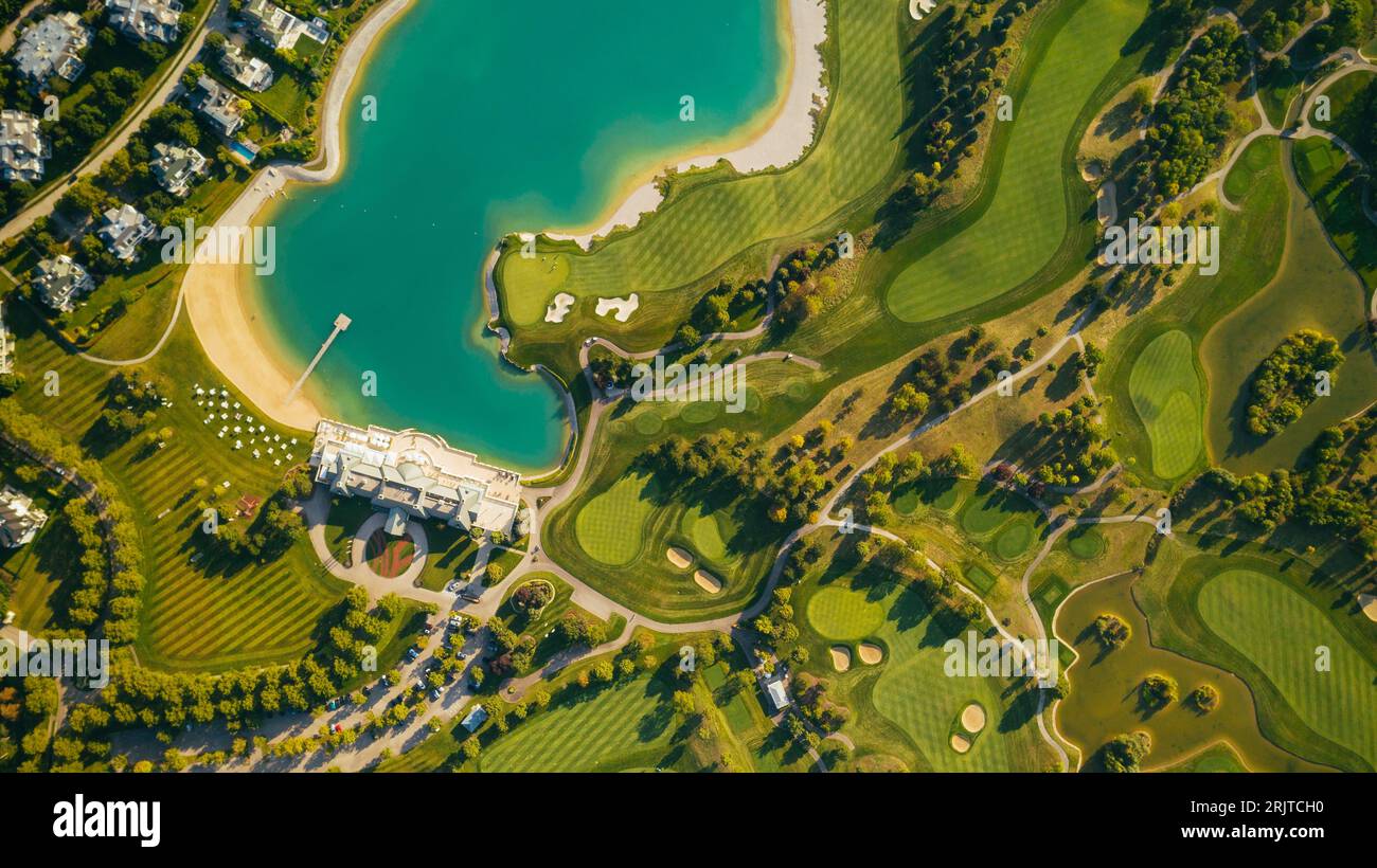 An idyllic landscape featuring a tranquil lake situated adjacent to ...