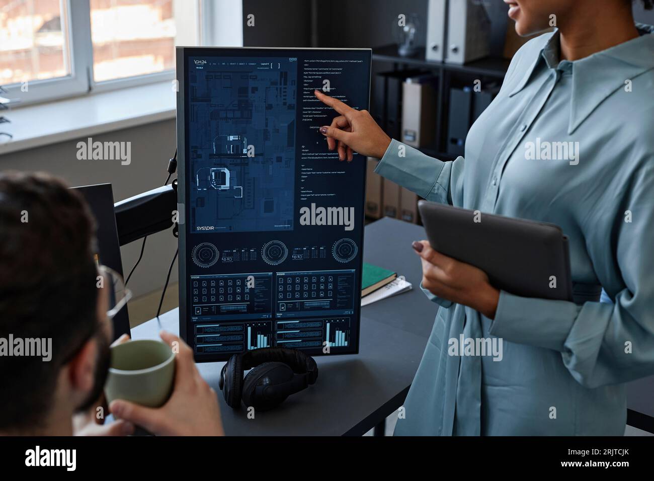 IT professional pointing on computer screen and having discussion with ...