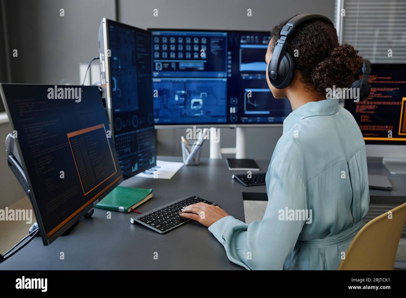 Computer Programmer Coding And Working On Desktop Pc At Desk Stock