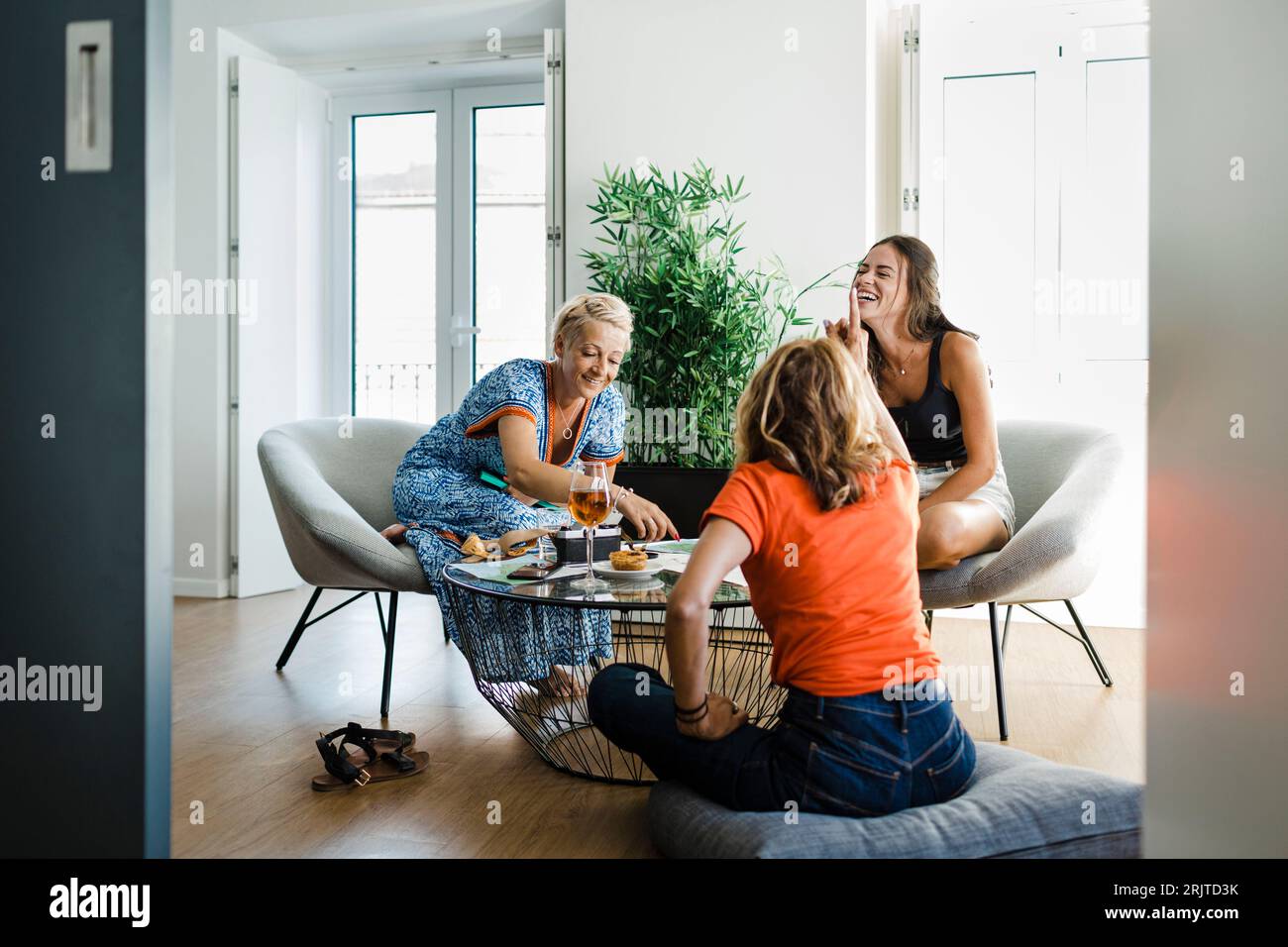 Happy friends enjoying and having snacks together in apartment Stock ...