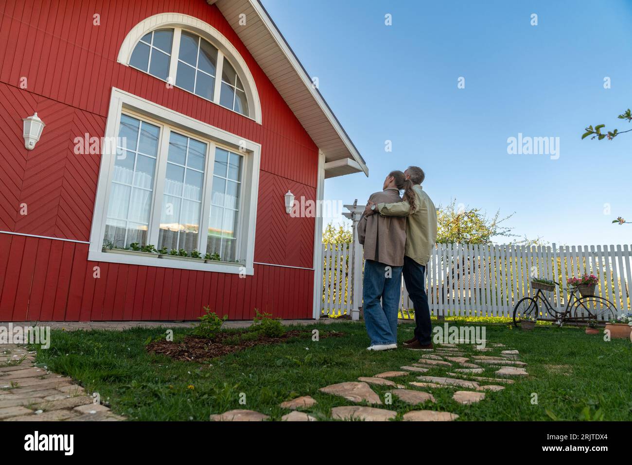 Man and woman admiring house Stock Photo - Alamy