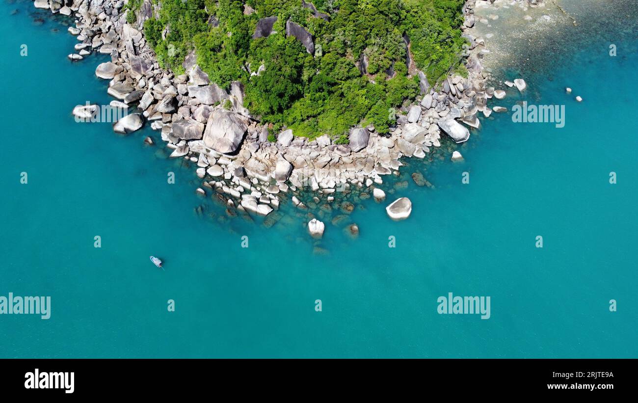 An idyllic tropical island landscape featuring numerous rocky outcrops ...