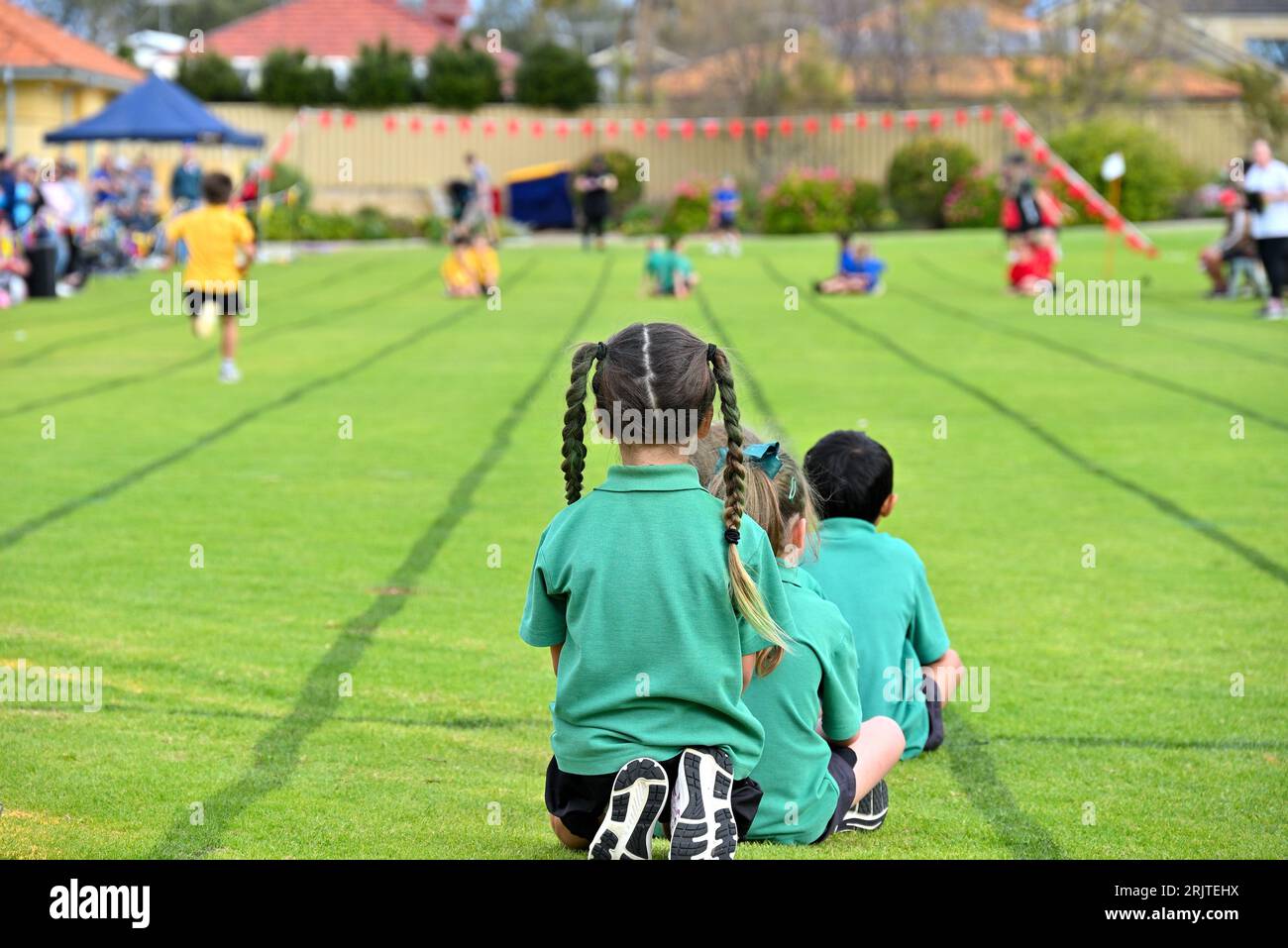 A primary school faction colour relay race. Kids photographed from ...