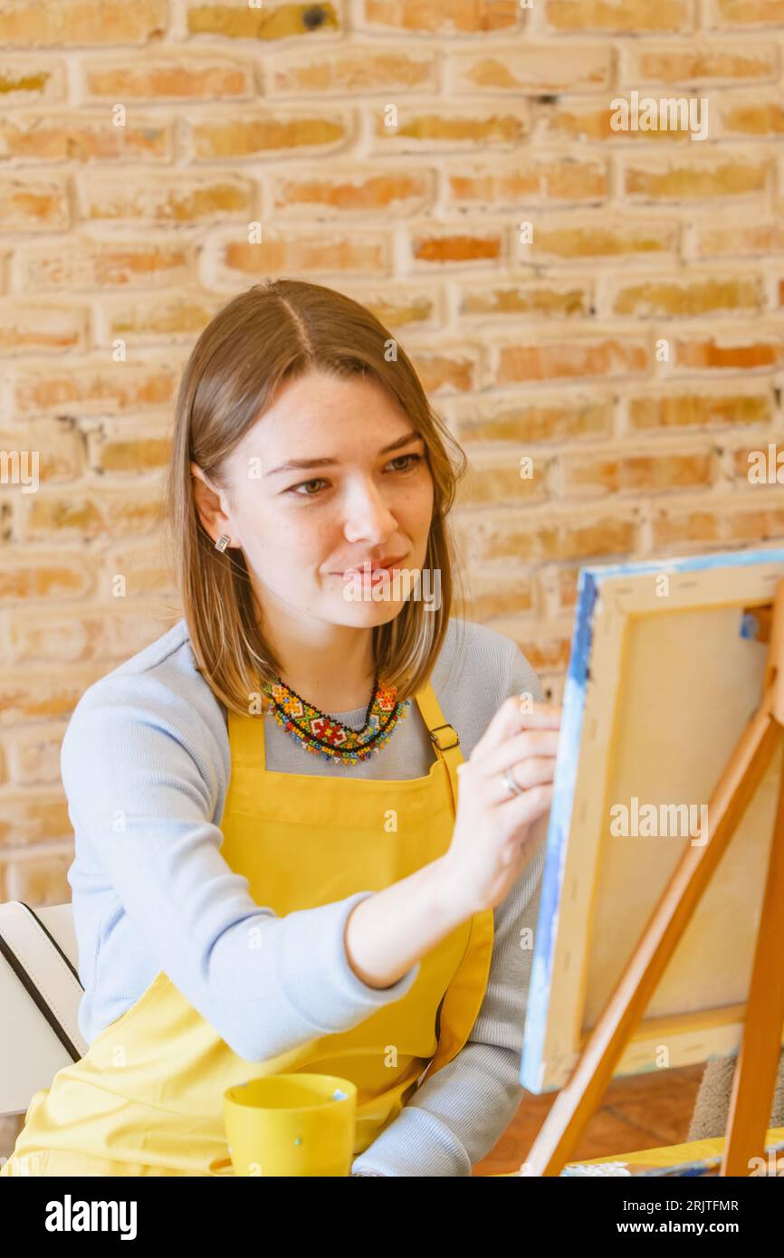 Woman paint brush canvas friends hi-res stock photography and images ...