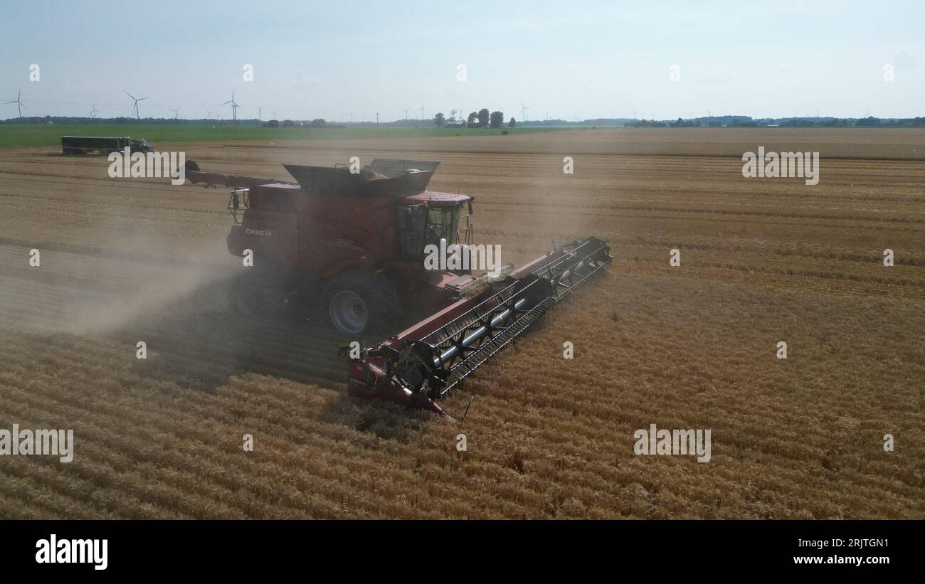 An aerial view of a red combine harvester in action in a field Stock ...