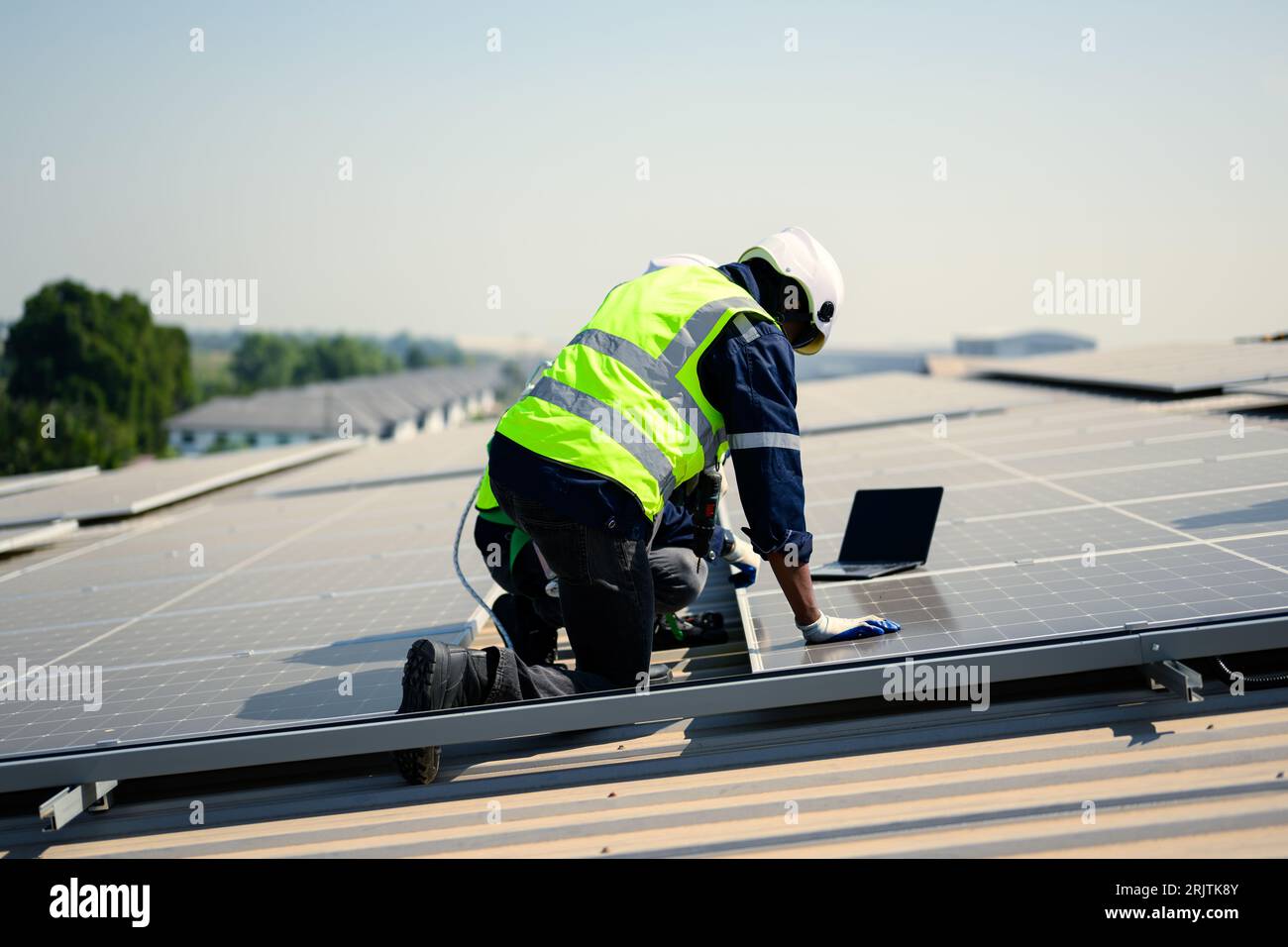 Engineers with safety helmet checking solar system at solar power farm ...