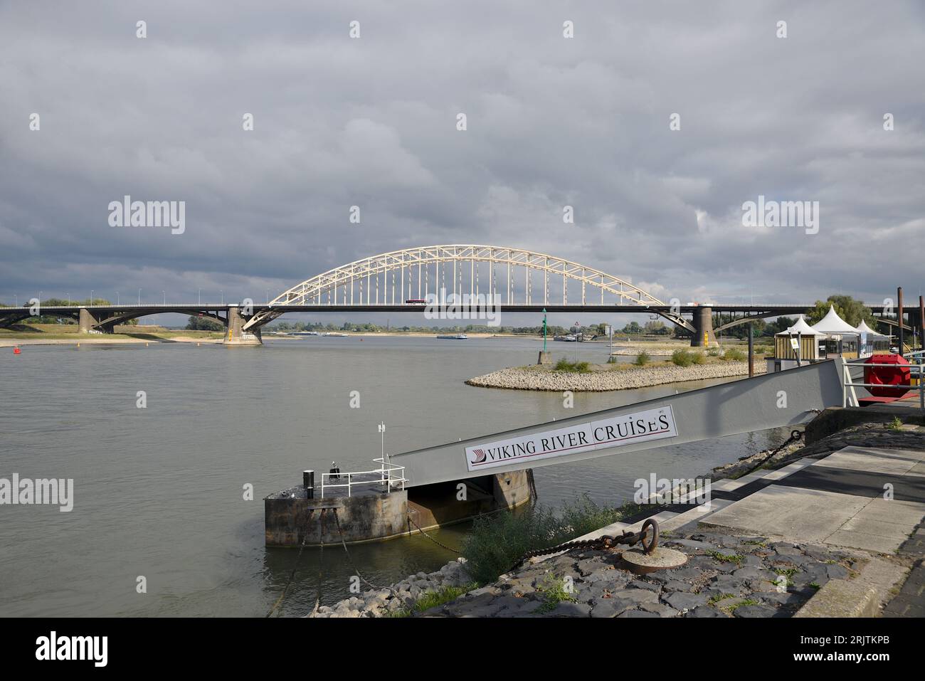 View of the Waal bridge. Inland shipping vessel sails under the Waal ...