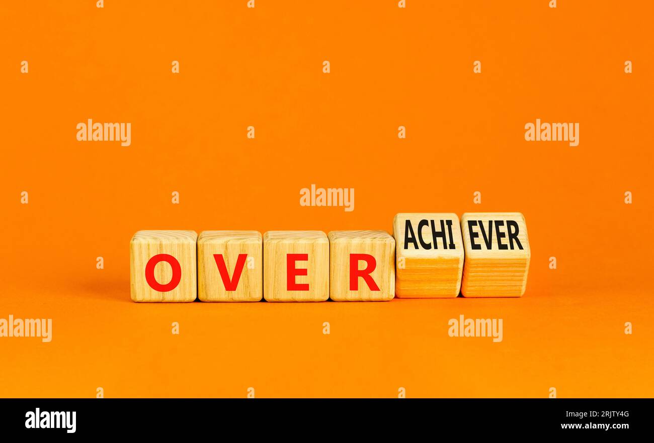 Achiever or overachiever symbol. Businessman turns wooden cubes and ...