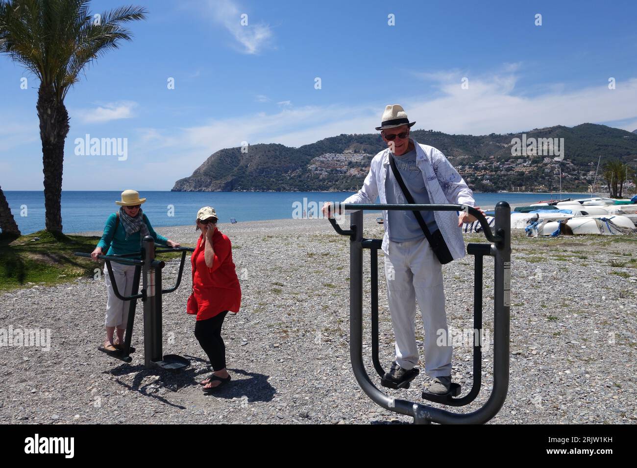 Tourists using public keep fit exercise machines on Herradura beach in ...