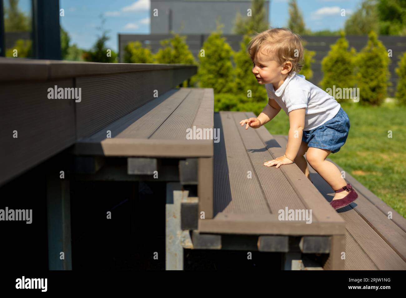 Cute little fair-haired kid on the steps Stock Photo - Alamy
