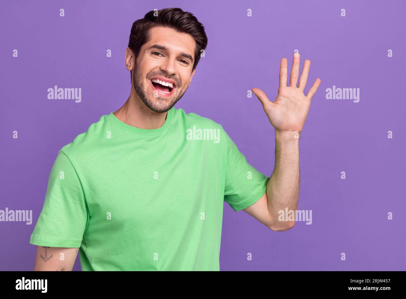 Photo portrait of young funky man waves palm hi hello sign greetings ...