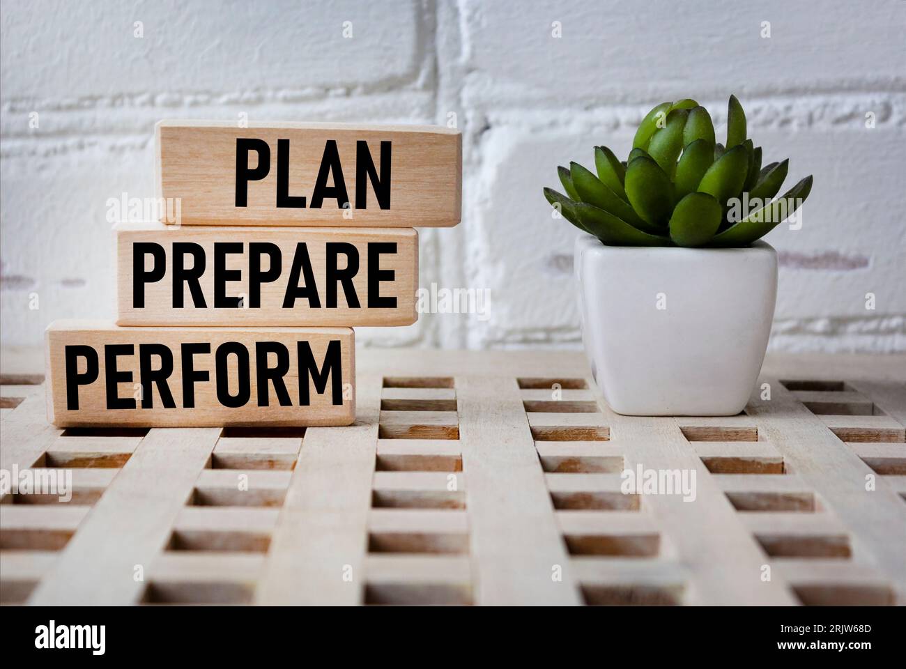 plan, prepare, perform words written on wooden blocks and vintage ...