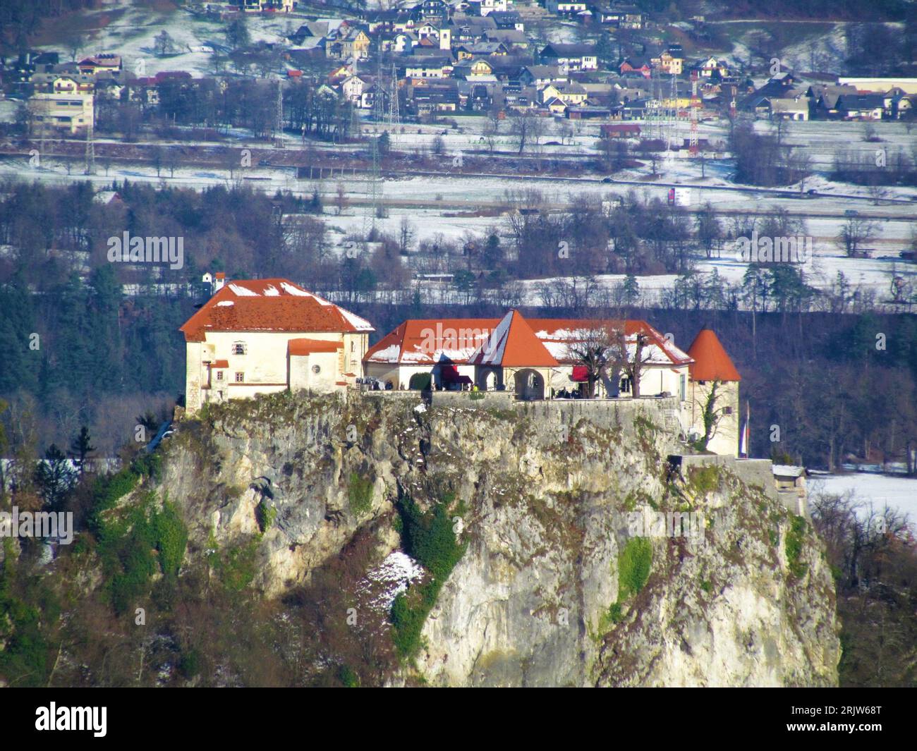 View of medieval Bled castle standing above a tall rock cliff ...