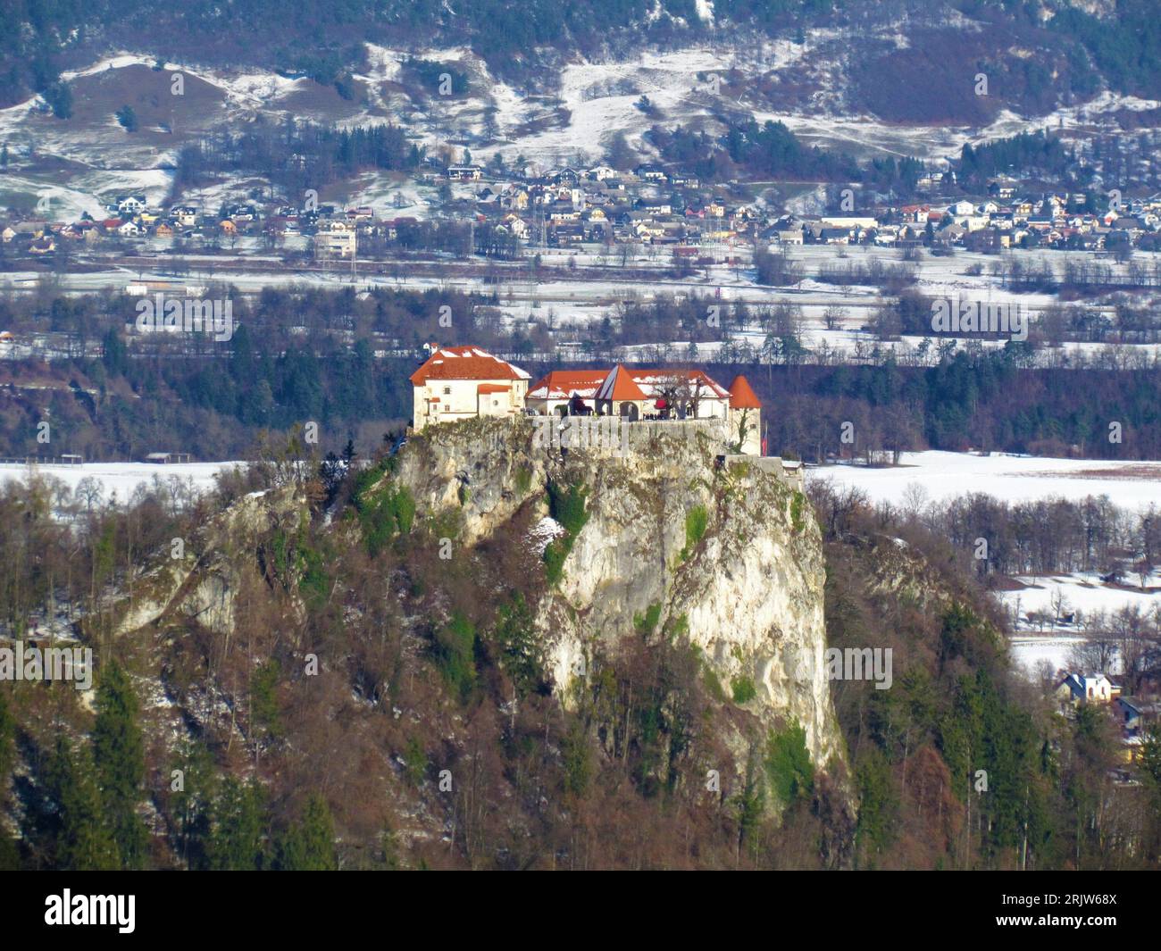 View of medieval Bled castle standing above a tall rock cliff ...