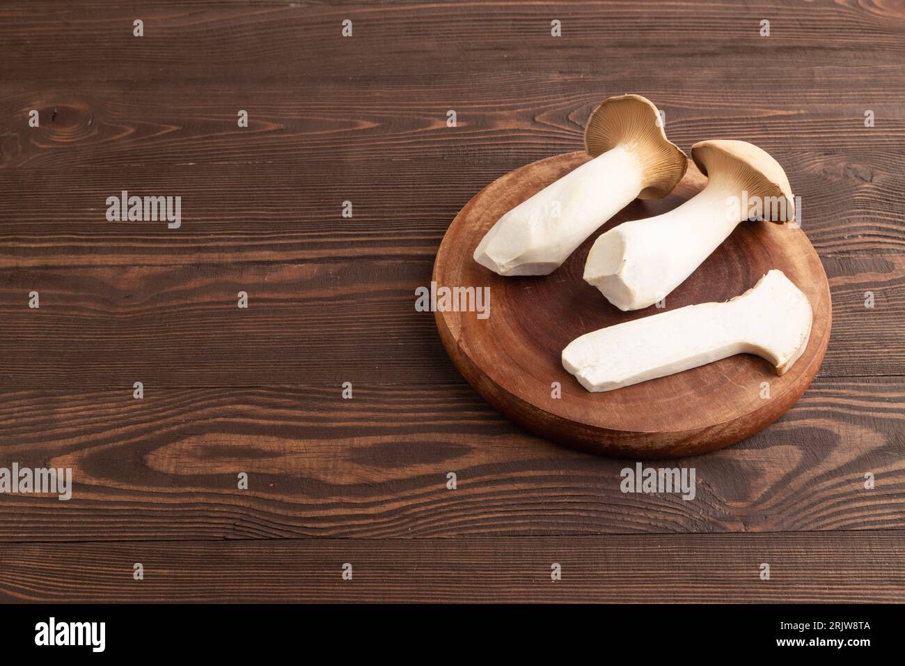 King Oyster mushrooms or Eringi (Pleurotus eryngii) on brown wooden ...