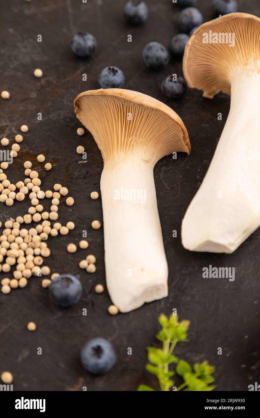 King Oyster mushrooms or Eringi (Pleurotus eryngii) on black concrete ...