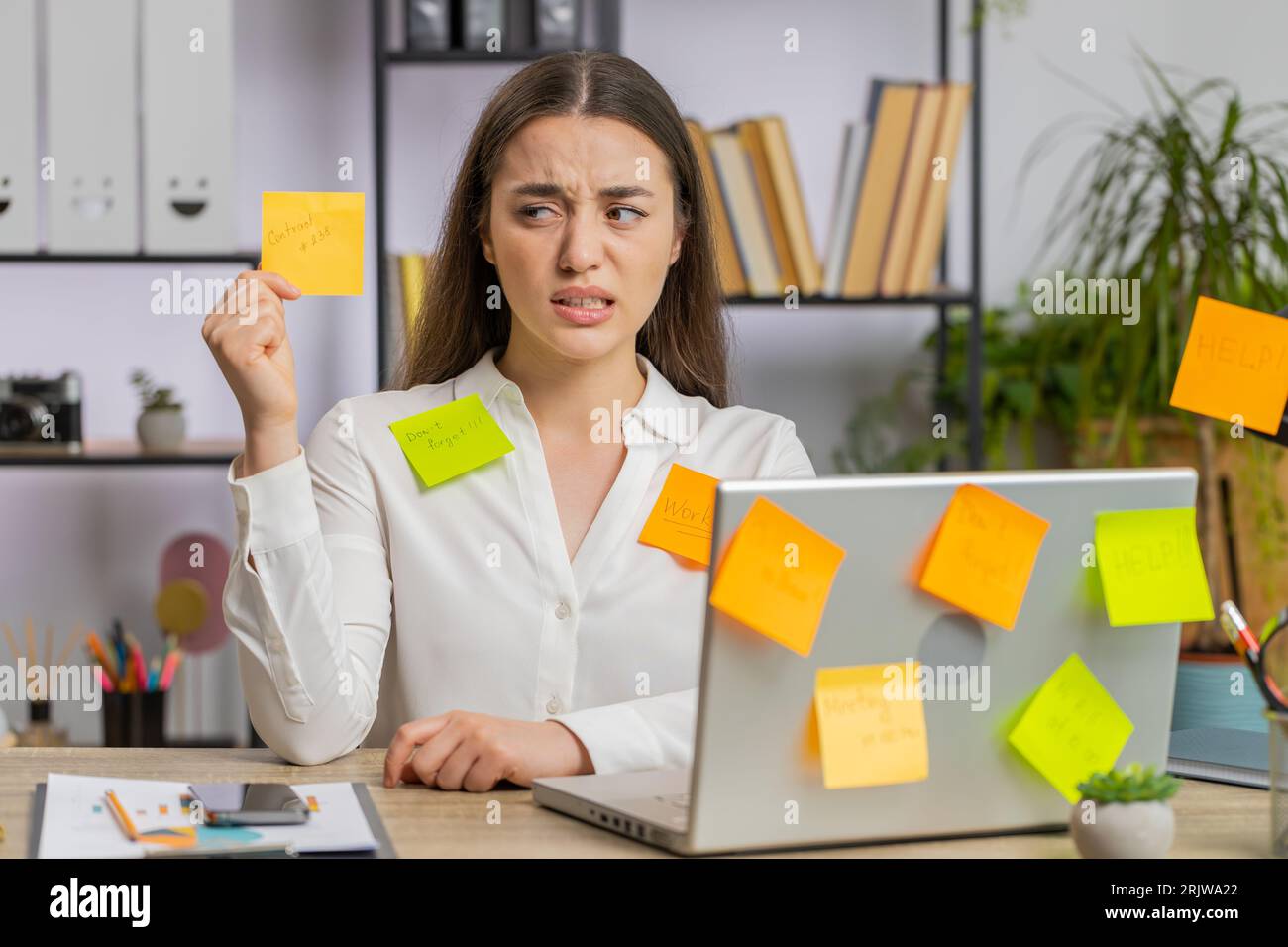 Tired exhausted young business woman working on laptop at office with ...