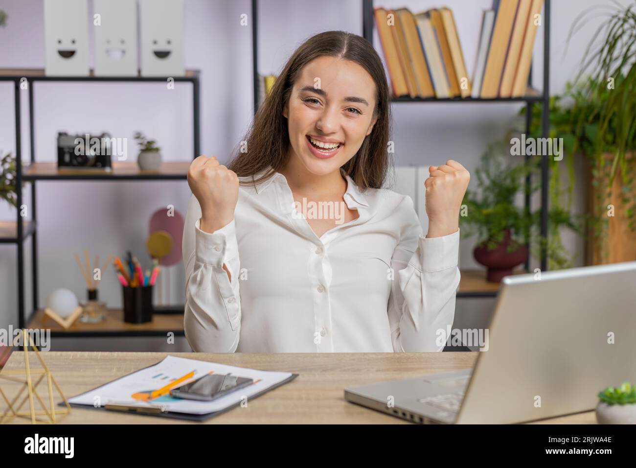 Happy amazed Caucasian business woman working on laptop shocked by ...