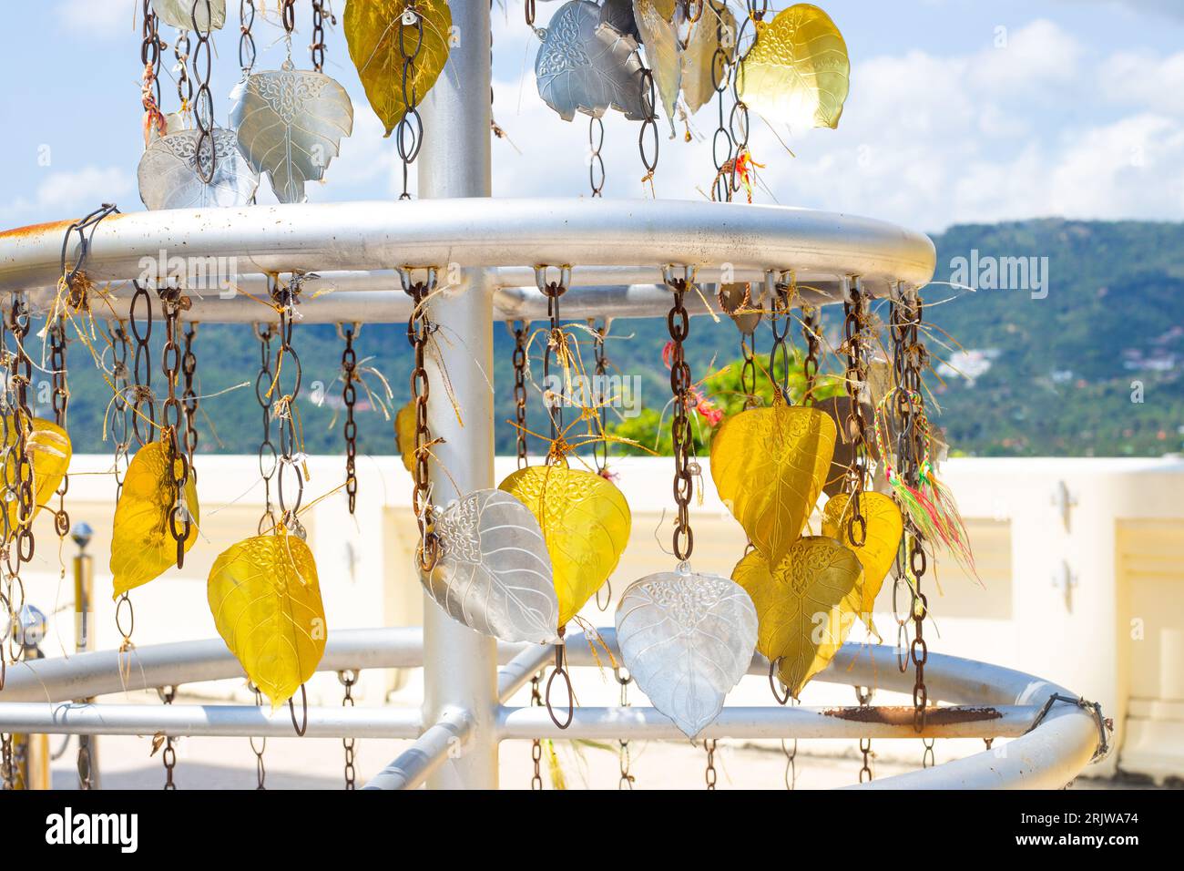 Gold and silver wish petals are tied to a wish tree in a Buddhist ...