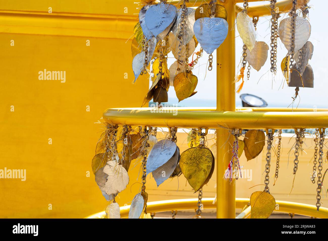 Gold and silver wish petals are tied to a wish tree in a Buddhist ...