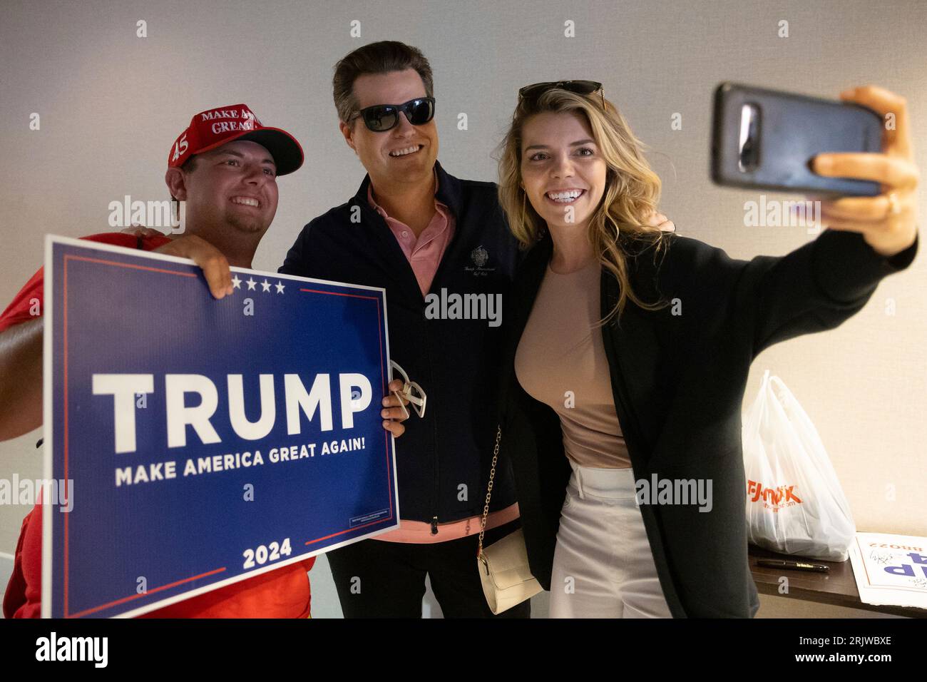 A supporter of former President Donald Trump poses for a selfie with ...