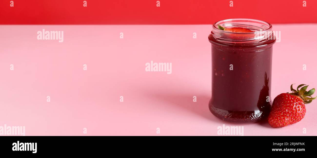 Jar of sweet strawberry jam on pink table. Banner for design Stock ...