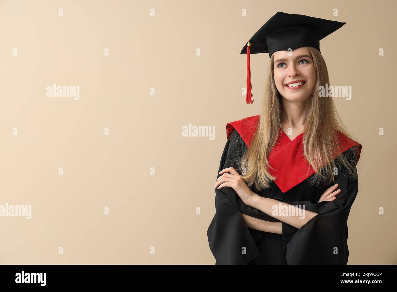 Female graduate student on beige background Stock Photo - Alamy