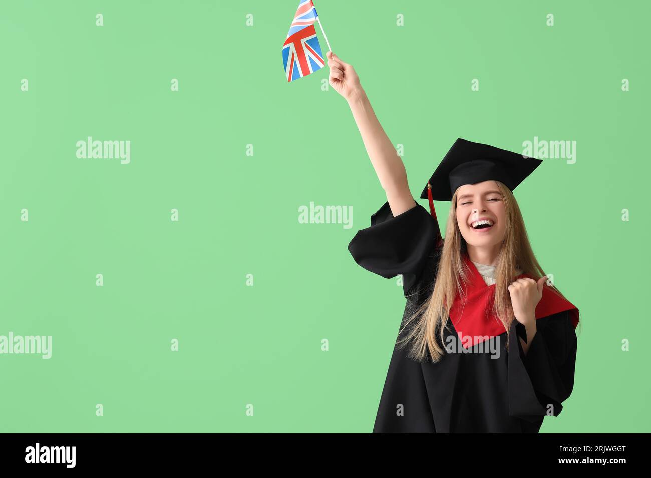 Female graduate student with UK flag on green background Stock Photo ...