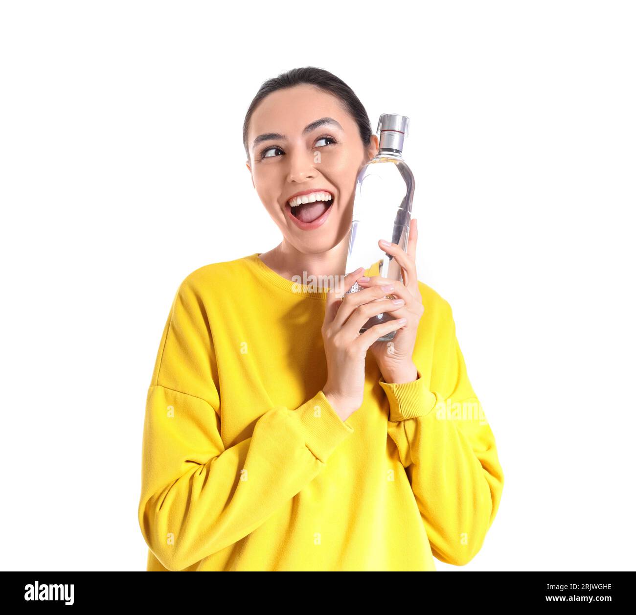 Young woman with bottle of vodka on white background Stock Photo - Alamy