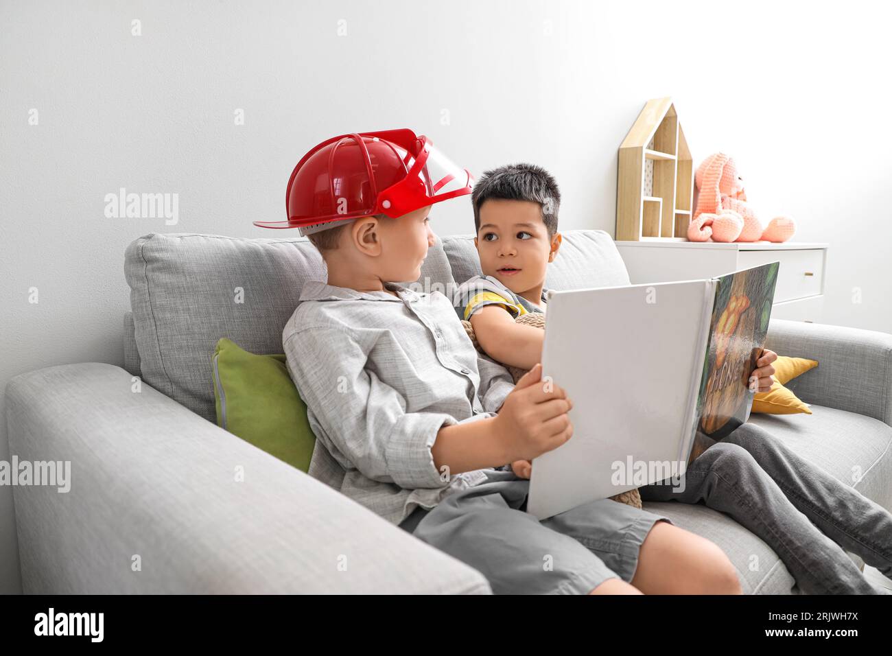 Cute little boys reading story at home Stock Photo - Alamy