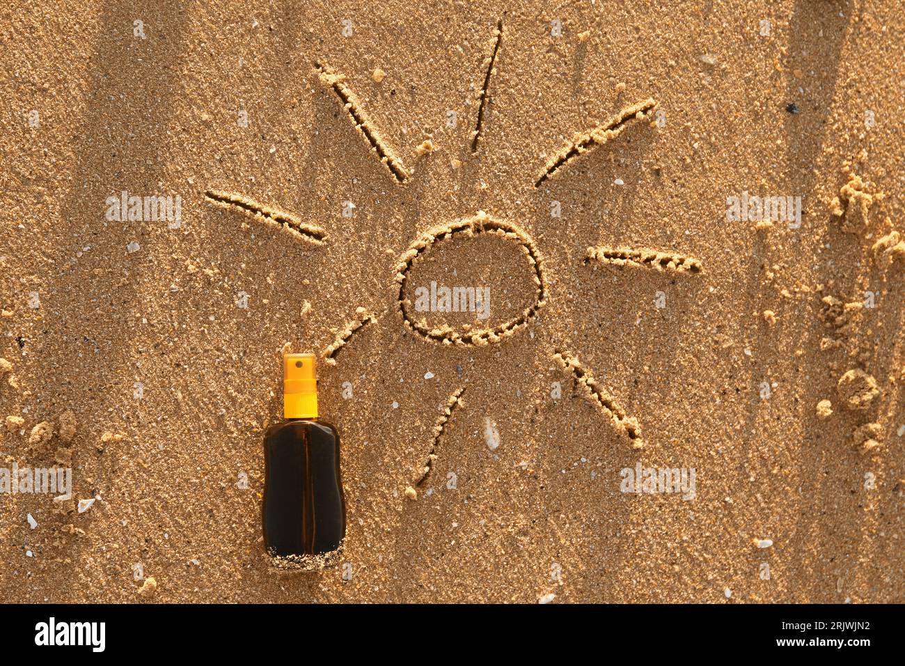 Creative composition with bottle of sunscreen cream on sand at sea ...
