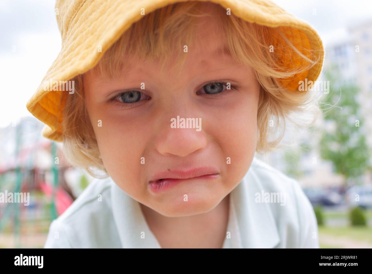 Offended little sad child cries and looks into the frame Stock Photo ...