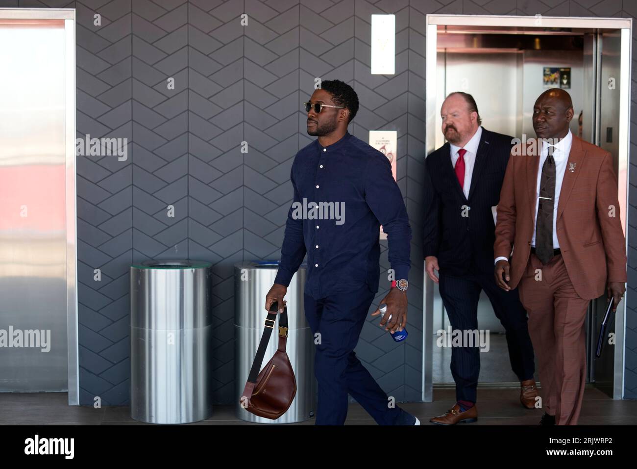 Former USC football player Reggie Bush, left, arrives with his ...