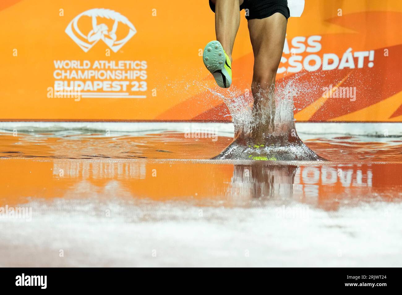 Athletes run through water during the women's steeplechase at the World ...
