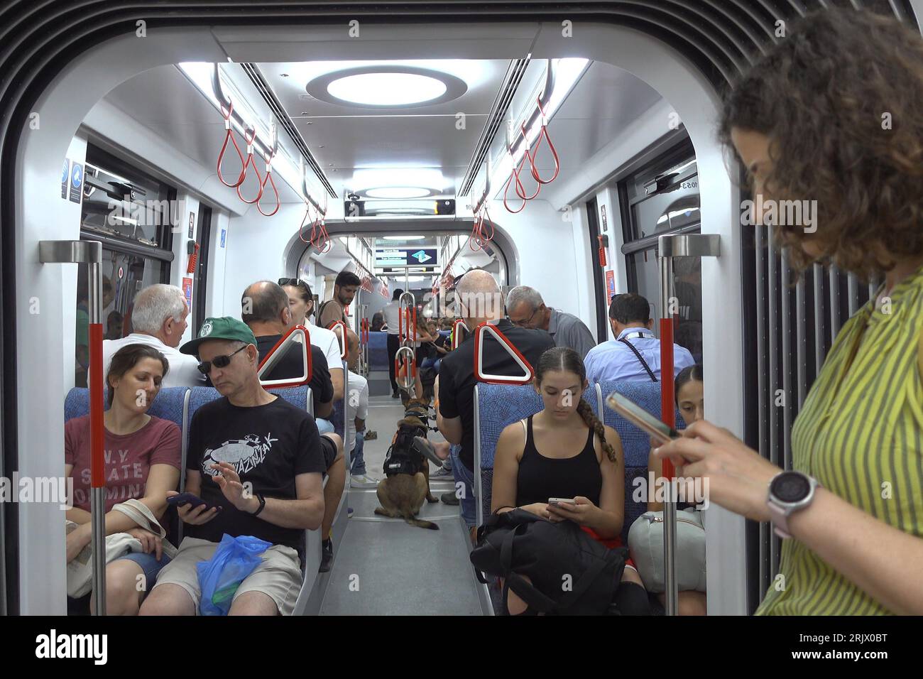 Passengers ride the train of the new metropolitan light rail system on ...