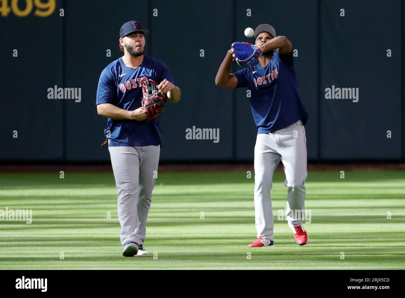 Boston Red Sox's Wilyer Abreu, left, and Pablo Reyes, right, take fly ...